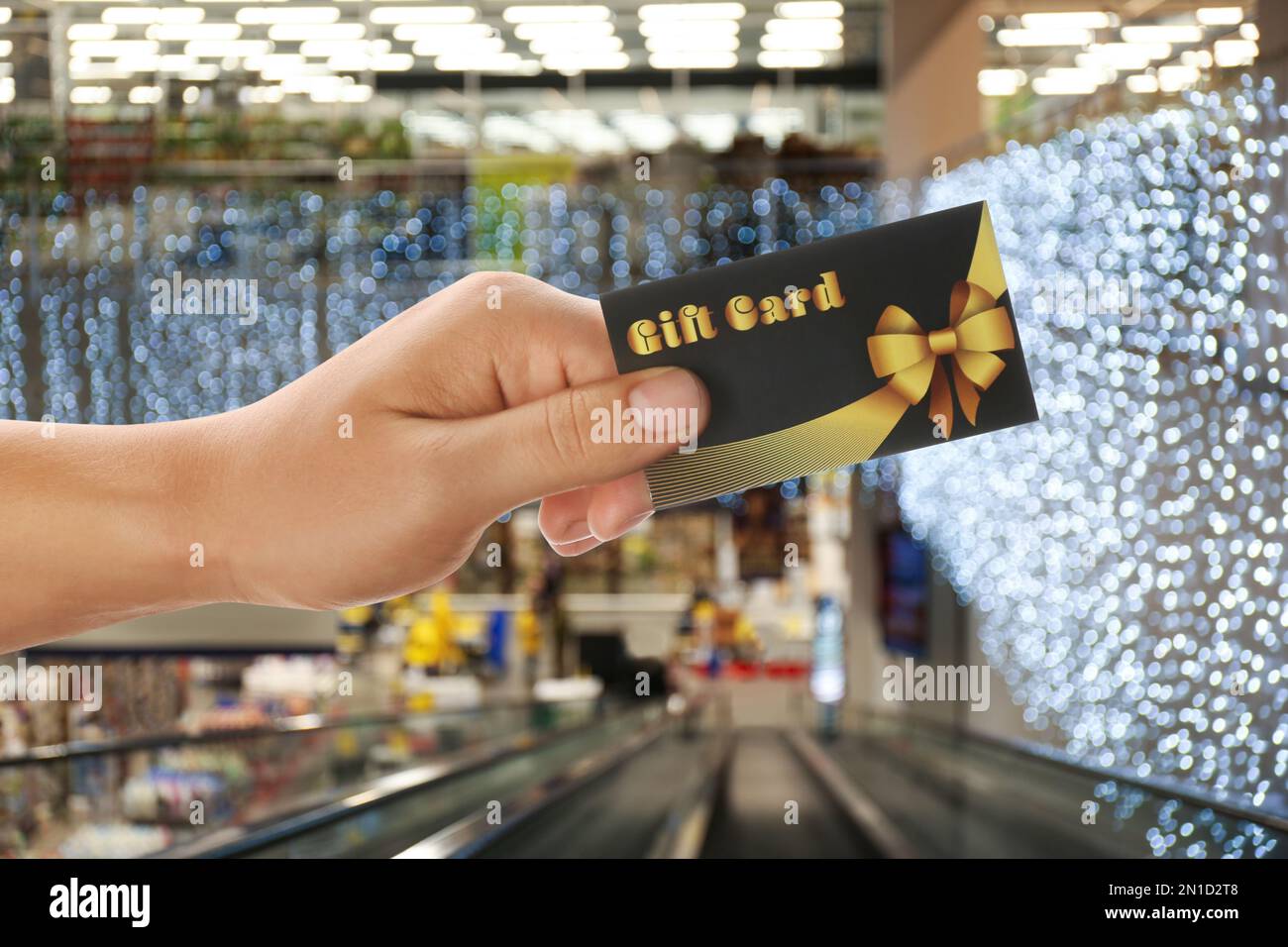 Man holding gift card in shopping mall, closeup Stock Photo - Alamy