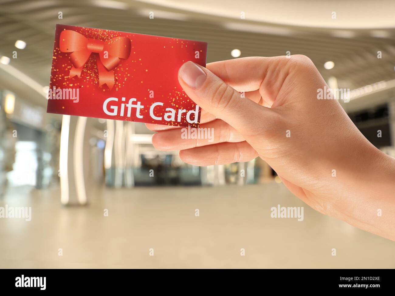 Woman holding gift card in shopping mall, closeup Stock Photo - Alamy