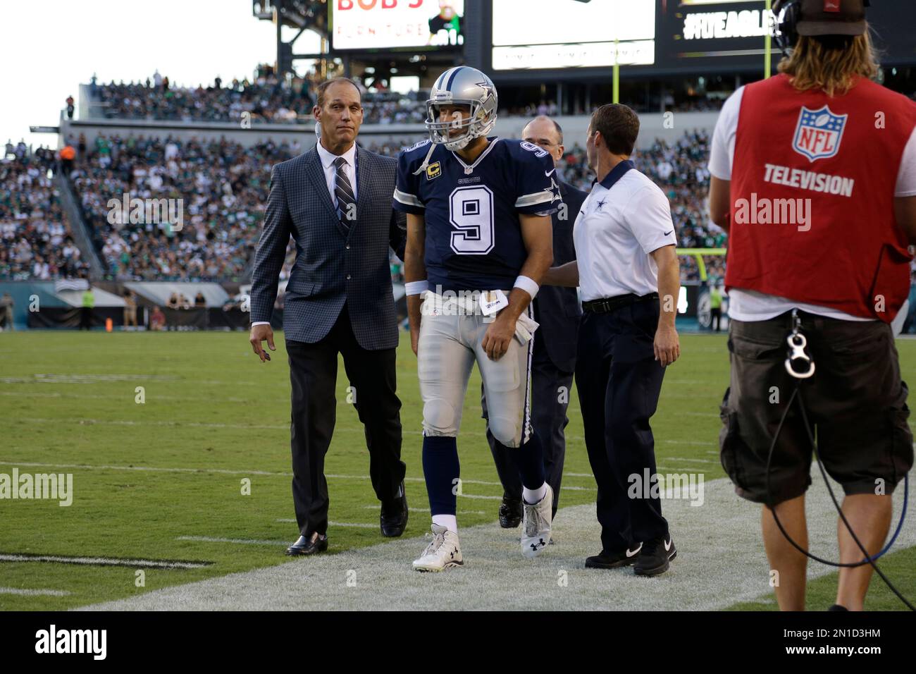 Dallas Cowboys' Tony Romo is helped off the field after an injury ...
