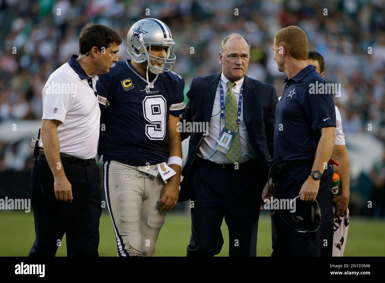 Dallas Cowboys' Tony Romo is helped off the field after an injury ...