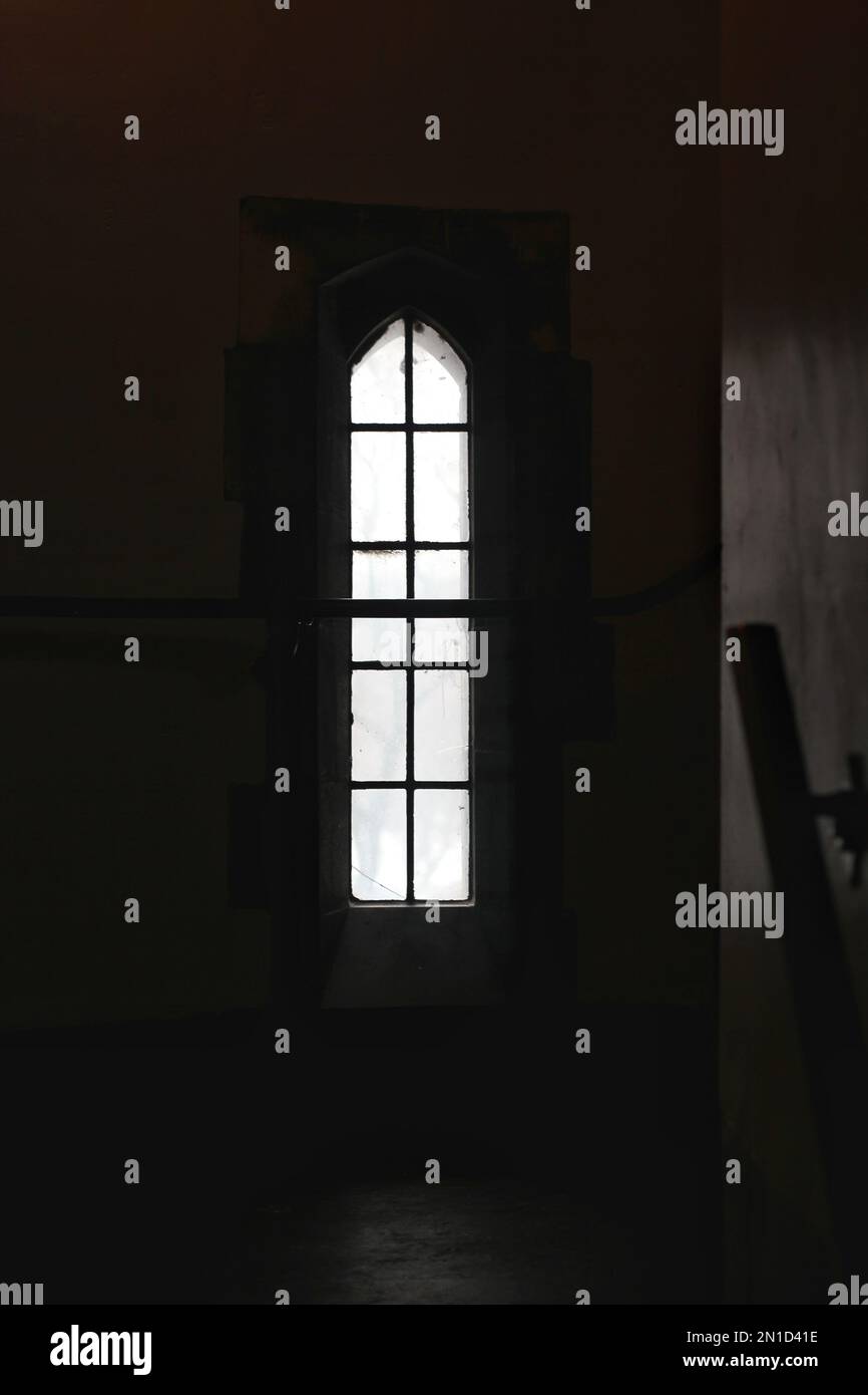 A glowing medieval window on a dark wall Stock Photo - Alamy