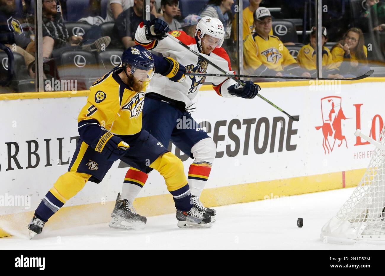 Nashville Predators defenseman Ryan Ellis (4) battles for the puck with ...