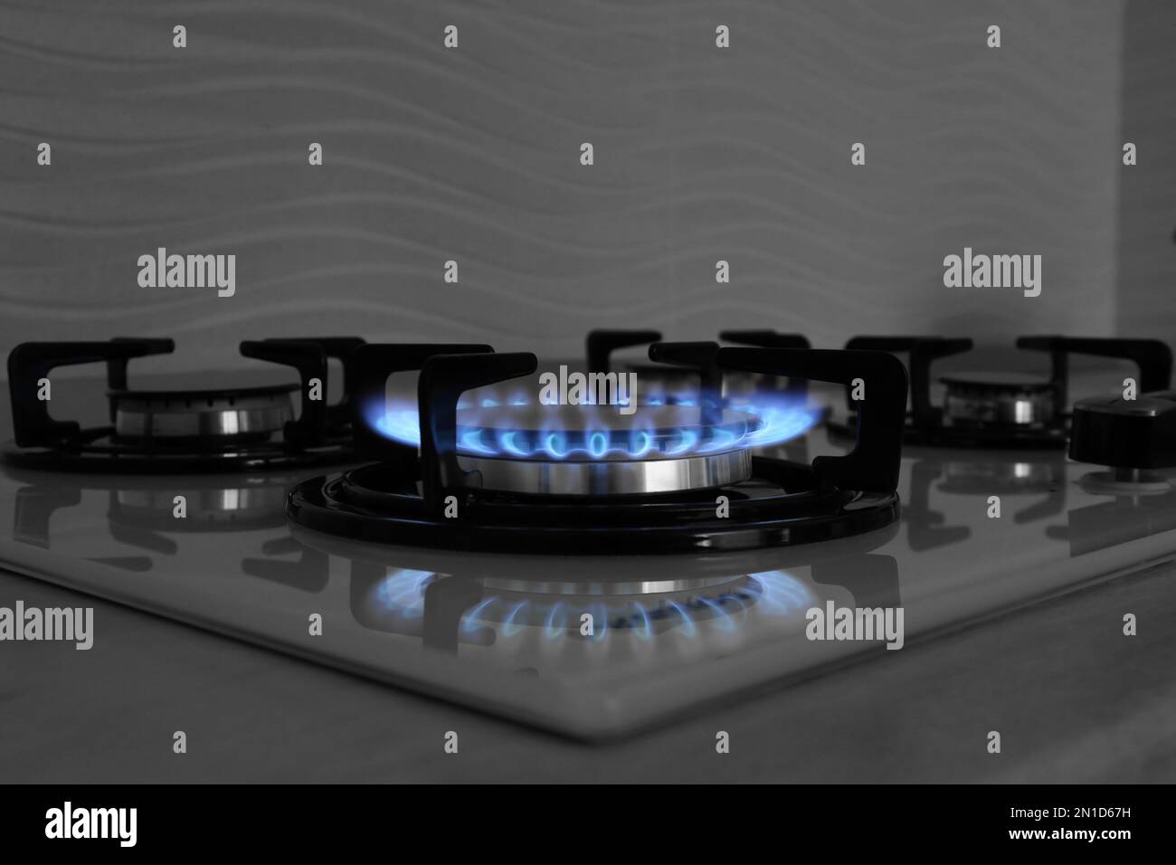 Modern gas cooktop with burning blue flame in kitchen Stock Photo - Alamy