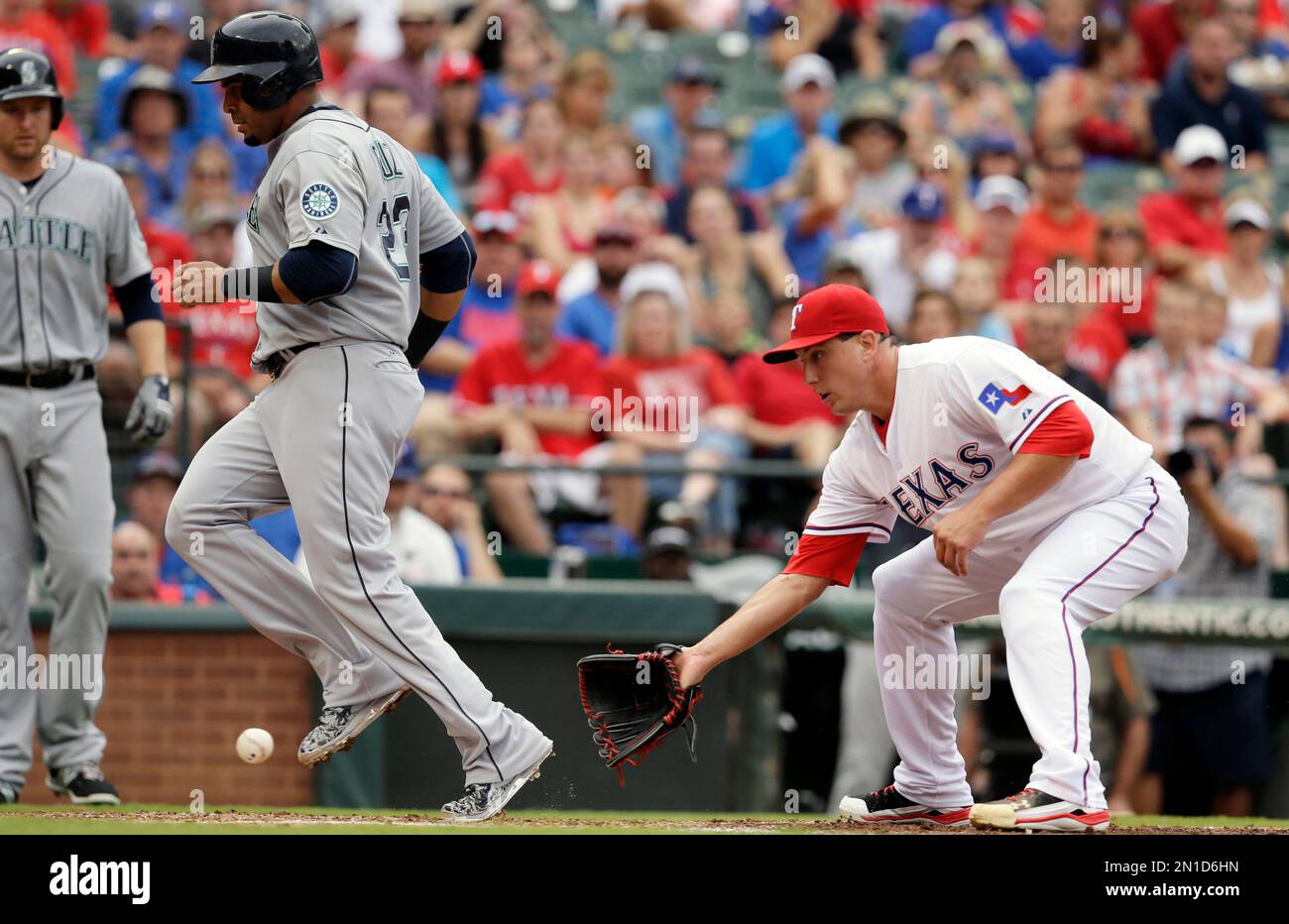 Seattle Mariners Nelson Cruz (23) scores on wild pitch by Texas Rangers ...
