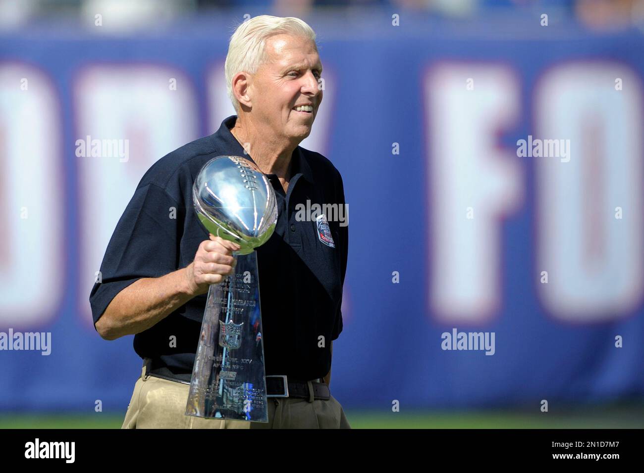 Former New York Giants head coach Bill Parcells walks with the Super ...