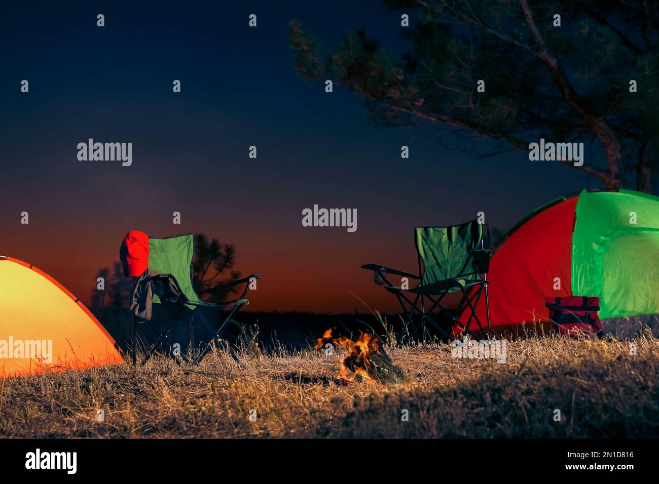 Camping tents and chairs in wilderness at night Stock Photo - Alamy