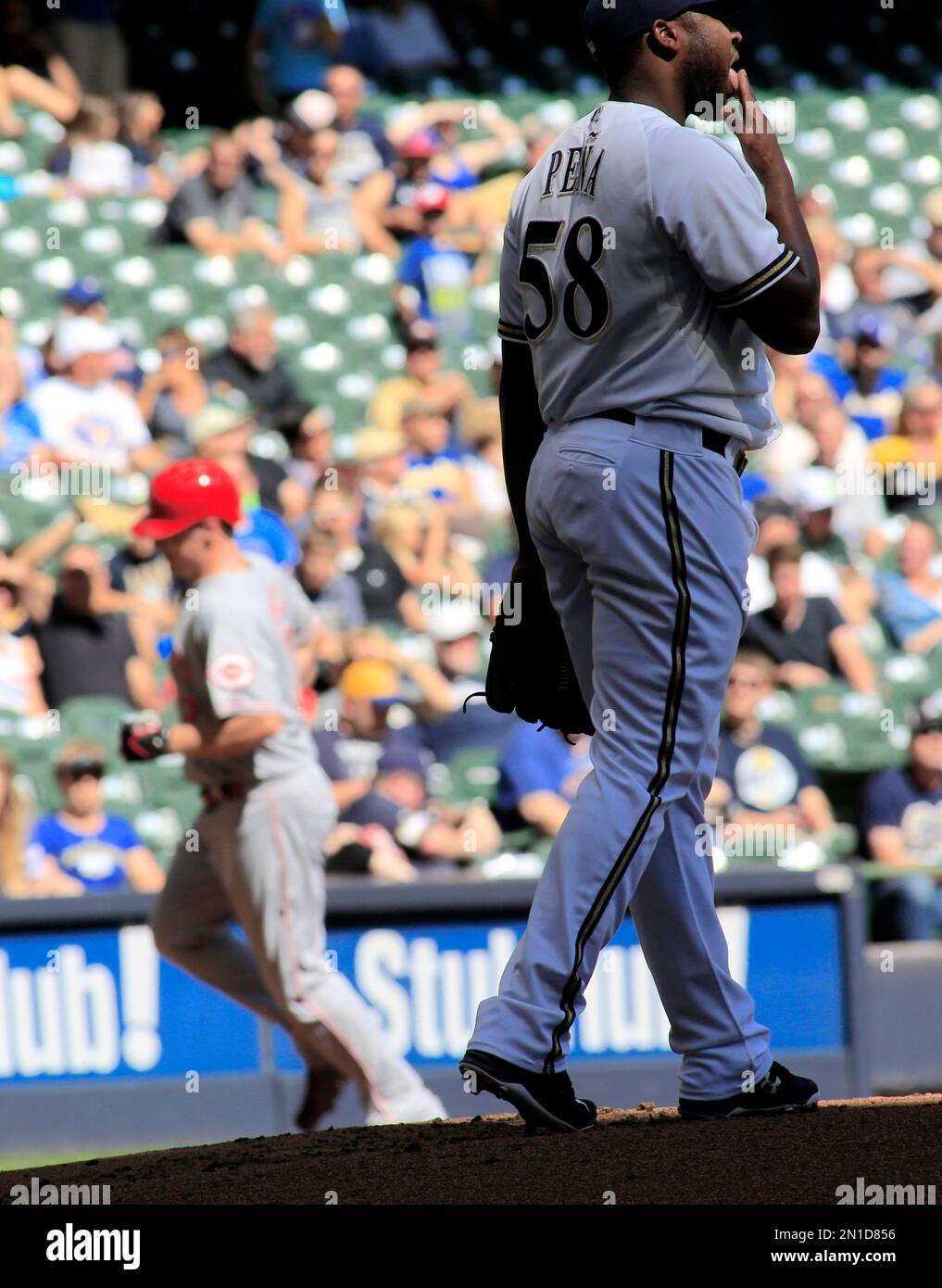 Milwaukee Brewers pitcher Ariel Pena, right, reacts after giving up a ...