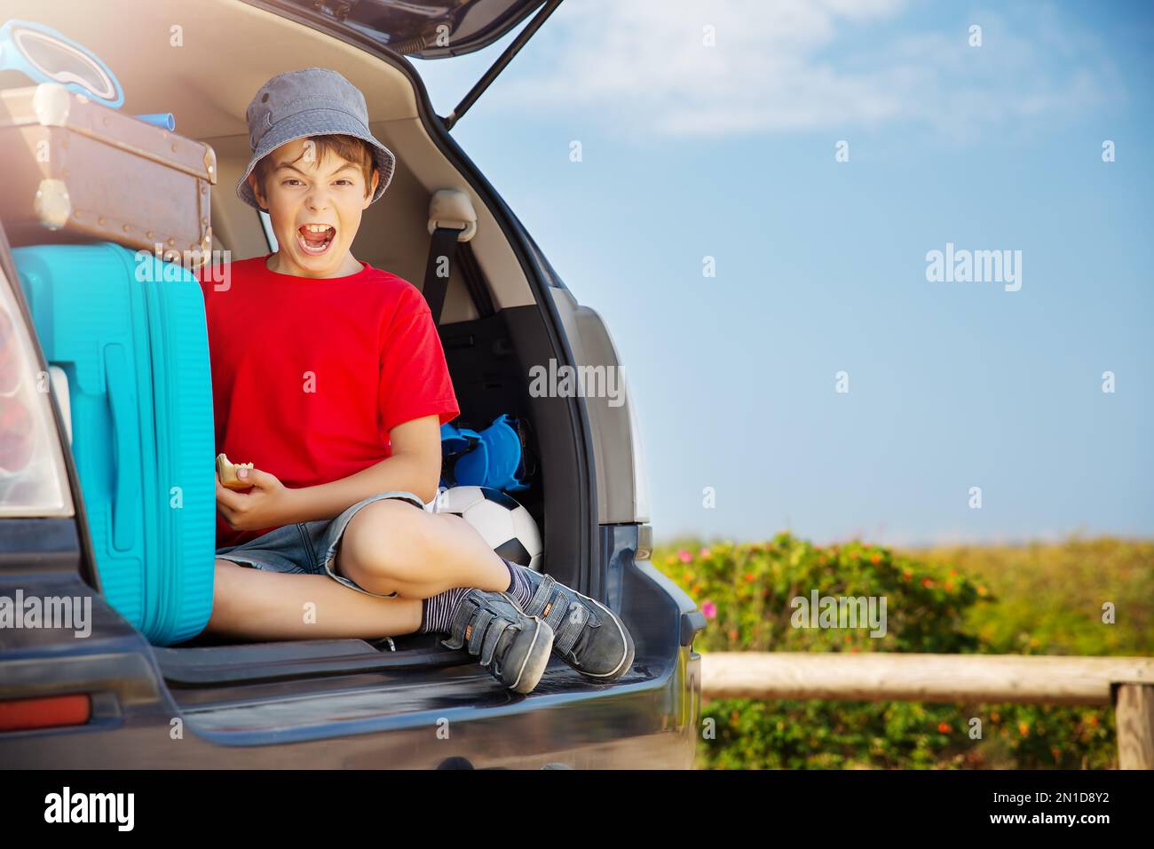 Cute child siting in the car and fooling around Stock Photo - Alamy