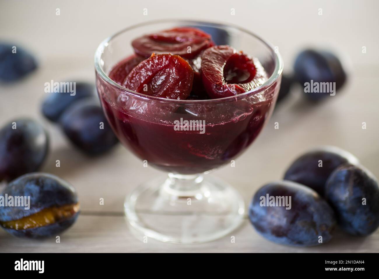 Sweet plums in syrup, in a glass bowl Stock Photo - Alamy