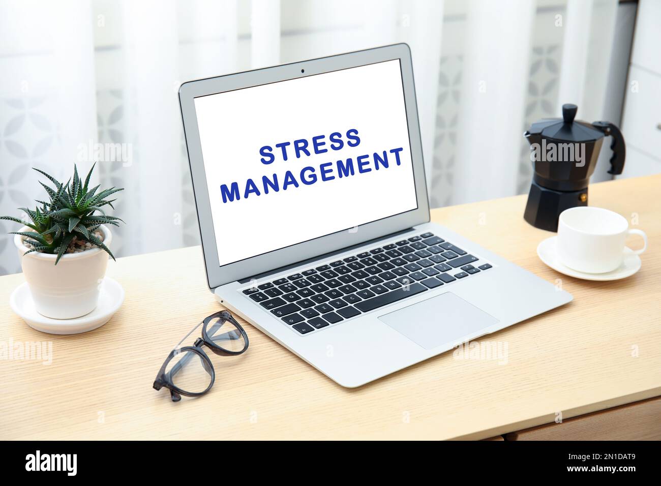 Laptop with text Stress Management on screen at workplace Stock Photo ...