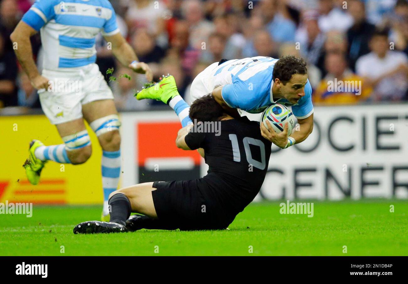 Argentina's Joaquin Tuculet is upended by New Zealand's Daniel Carter ...