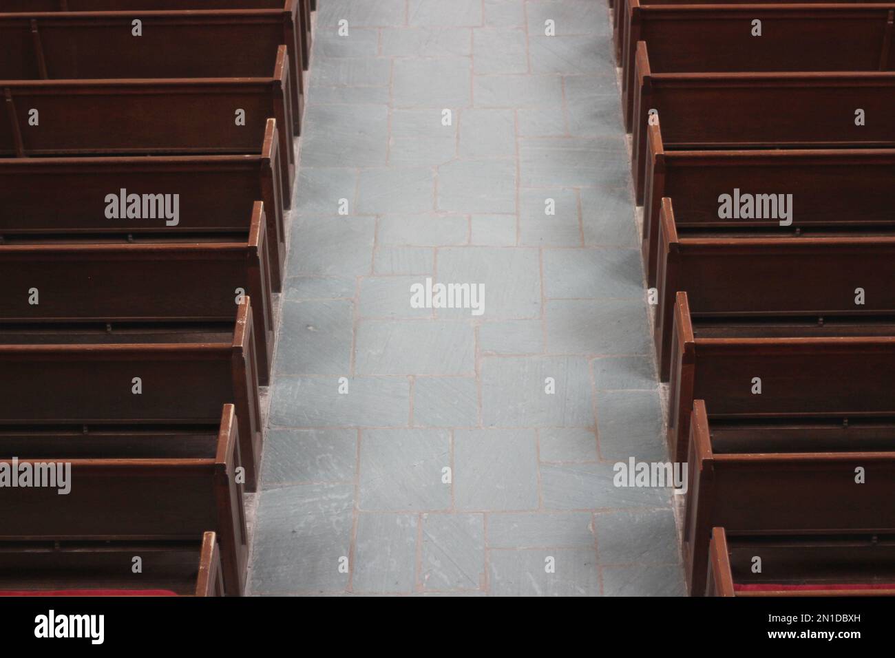 Minimalist view of rows of antique pews Stock Photo - Alamy