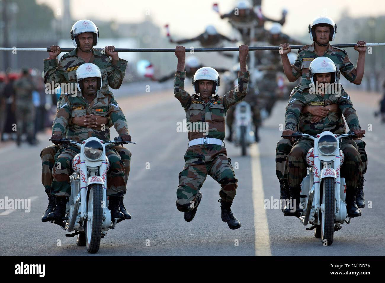 Indian army soldiers perform a daredevil motorcycle stunt during a ...
