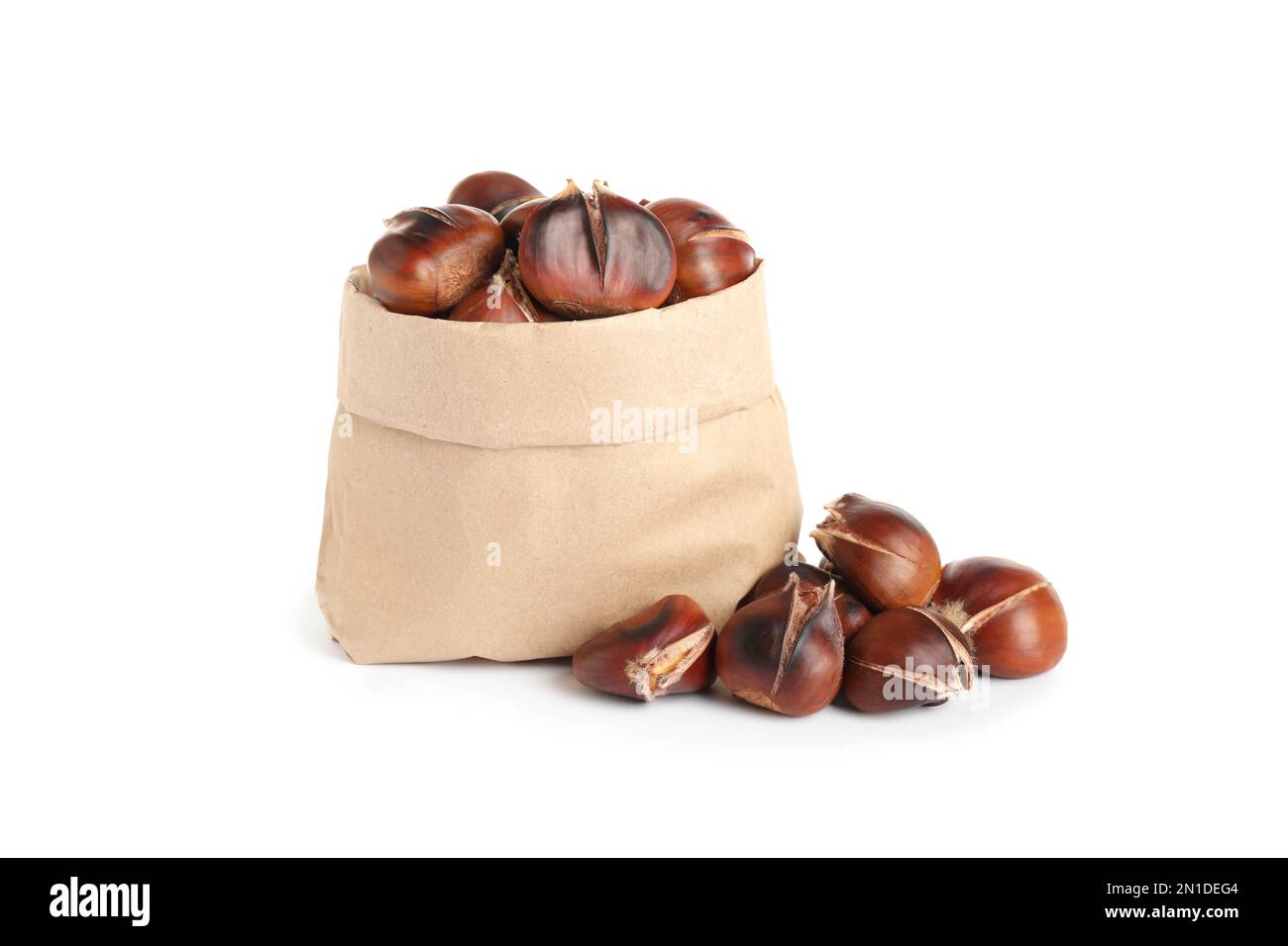 Paper bag with tasty roasted edible chestnuts on white background Stock ...