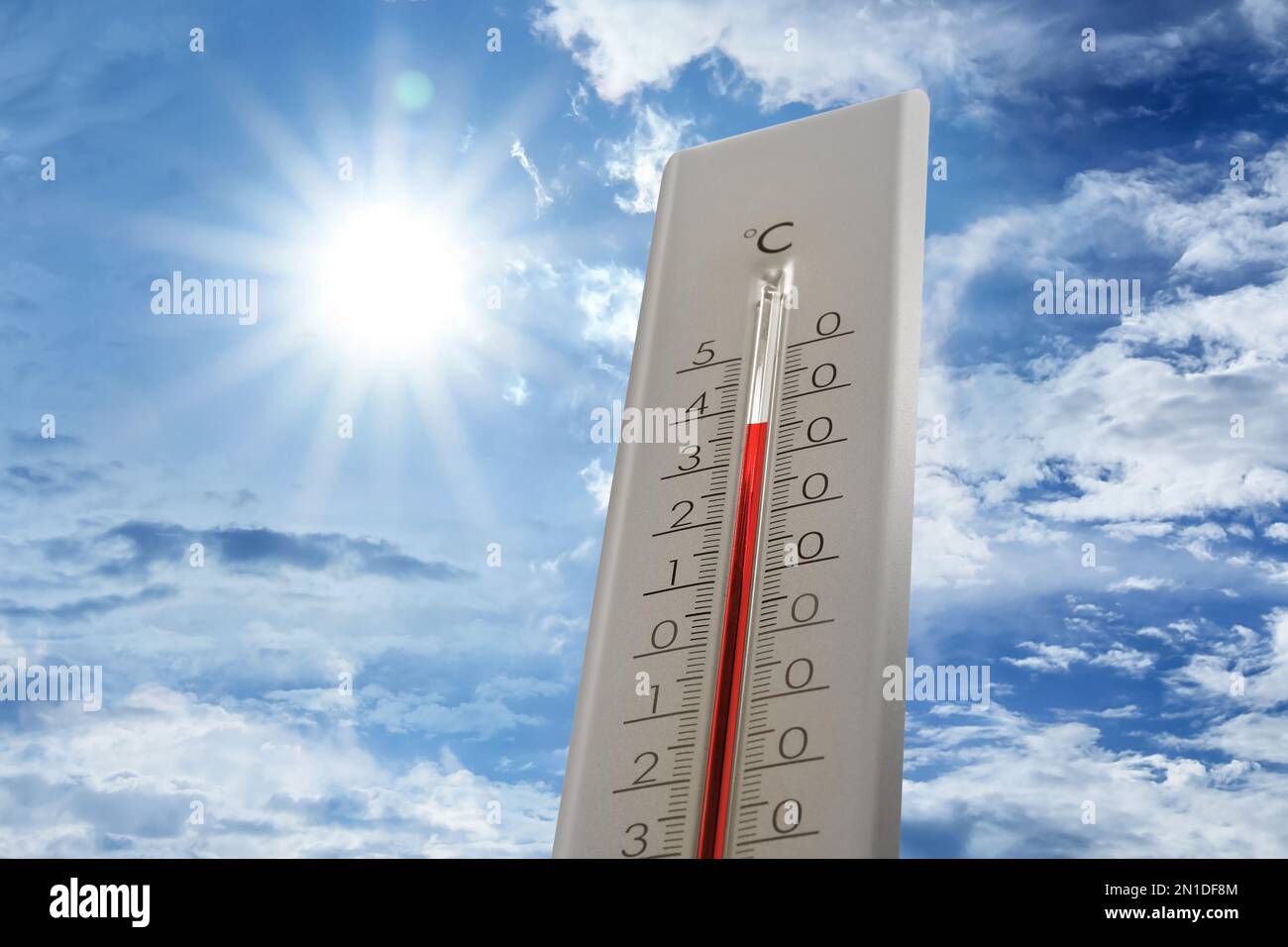 Weather thermometer showing high temperature and blue sky with clouds ...