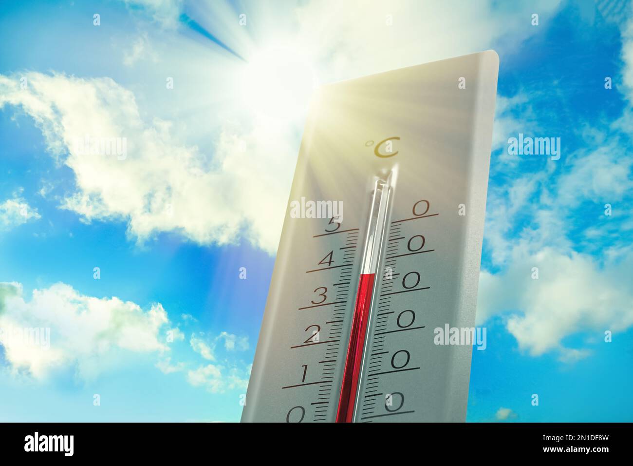 Weather thermometer showing high temperature and blue sky with clouds ...