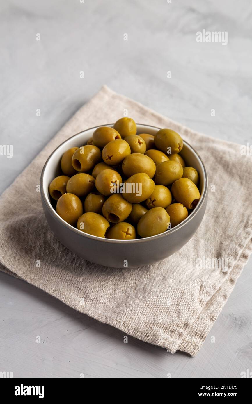 Marinated Green Pitted Olives in a Bowl, side view Stock Photo - Alamy