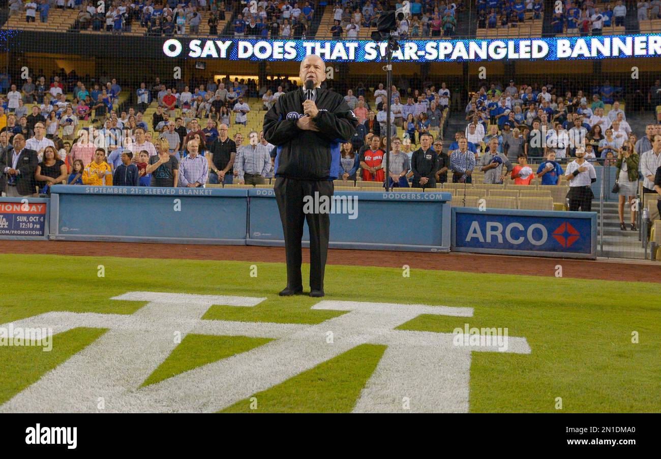 Frank Sinatra, Jr. sings the national anthem prior to a baseball game ...