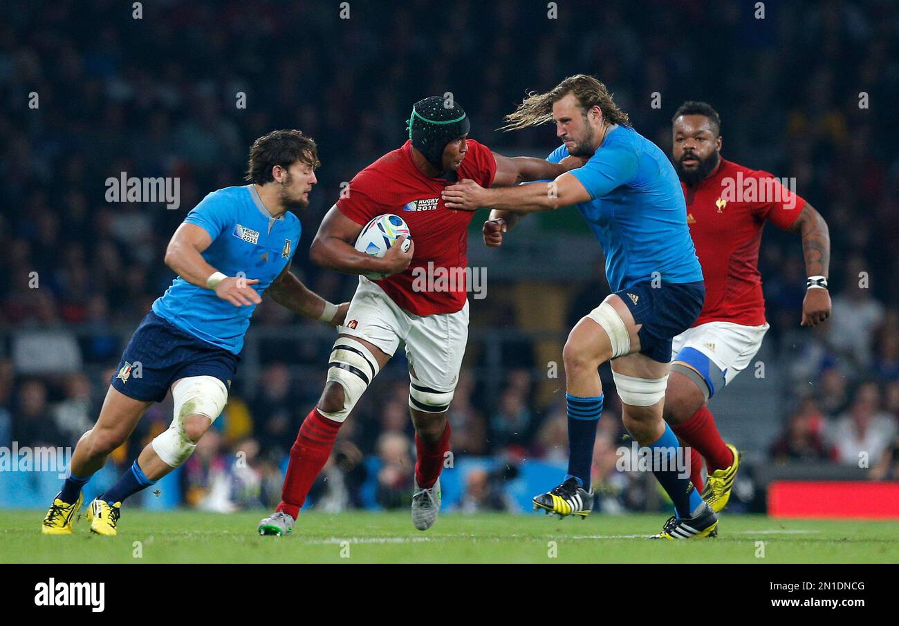 France's captain Thierry Dusautoir, center, is tackled by Italy's Josh ...