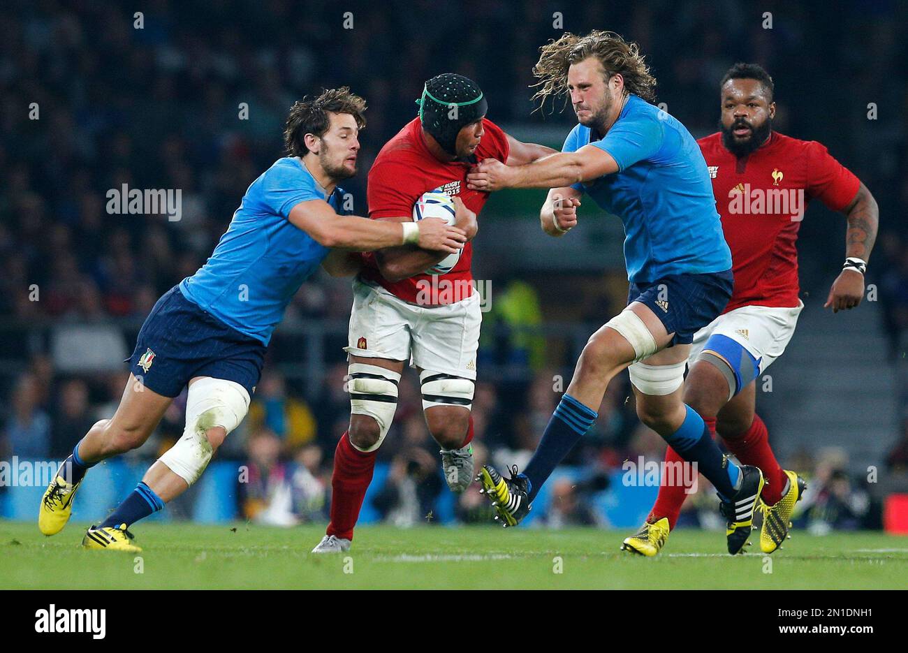 France's captain Thierry Dusautoir, center, is tackled by Italy's Josh ...