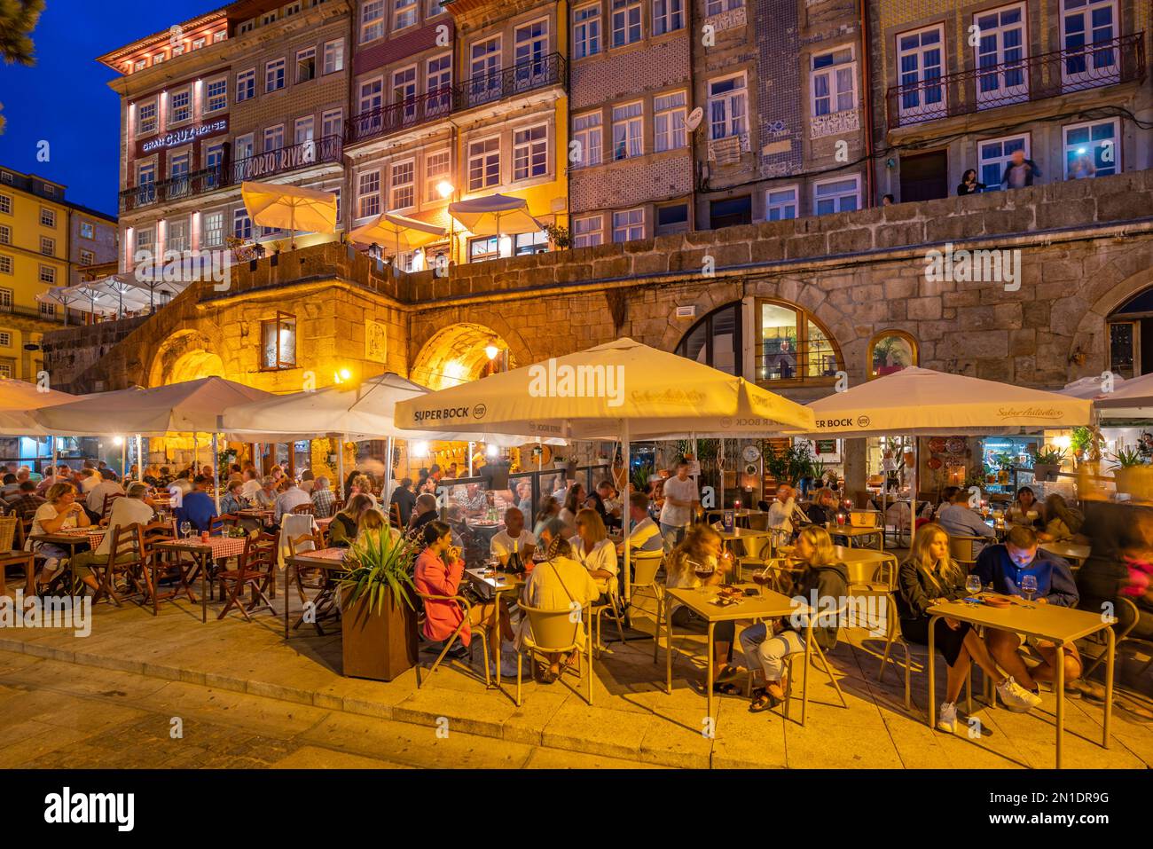 View of bars and restaurants at waterfront of Douro River at dusk ...