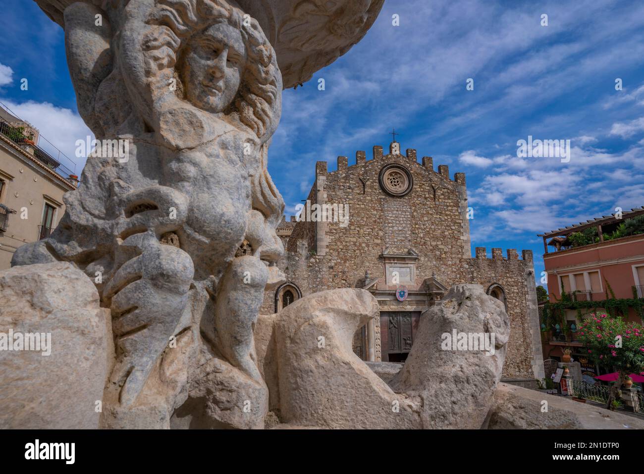 View of Duomo di Taormina and fountain in Piazza del Duomo in Taormina ...
