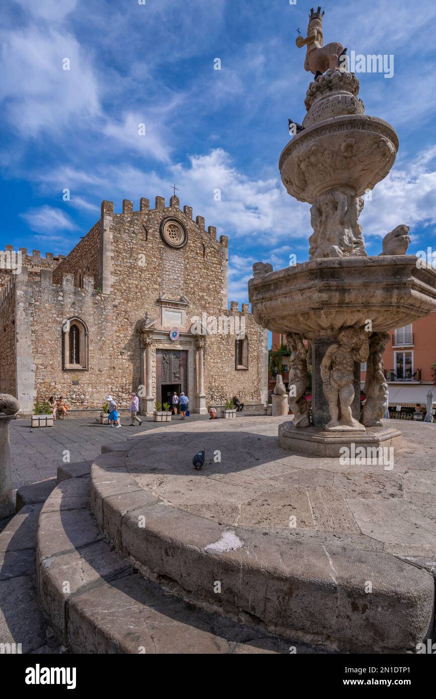 View of Duomo di Taormina and fountain in Piazza del Duomo in Taormina ...