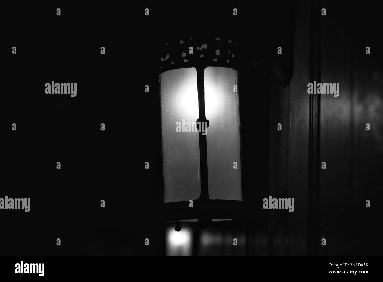 Vintage traditional medieval hall light glowing bright in the darkness ...