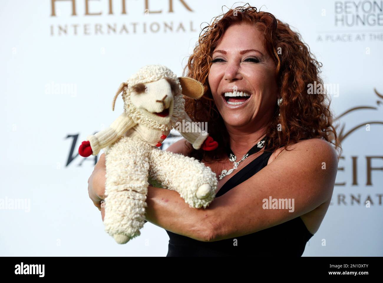 Mallory Lewis poses with "Lambchop" at the 4th Annual Beyond Hunger: "A ...