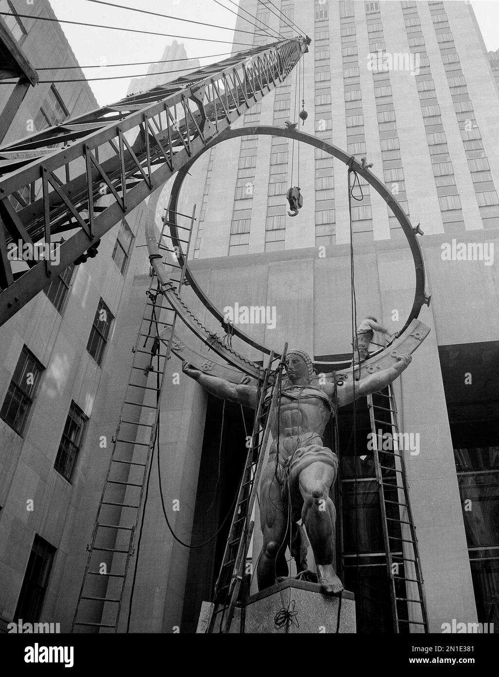 A sculpture of "Atlas," brother of "Prometheus," is put into place by a ...