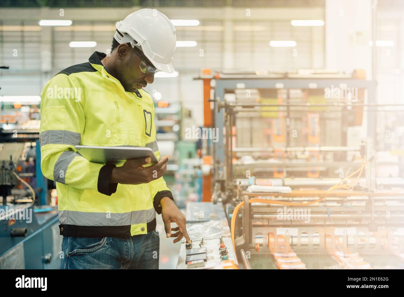 Technician working in factory check functionality while commissioning a ...