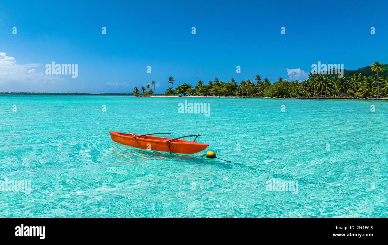Outrigger canoe in the lagoon of Maupiti, Society Islands, French ...