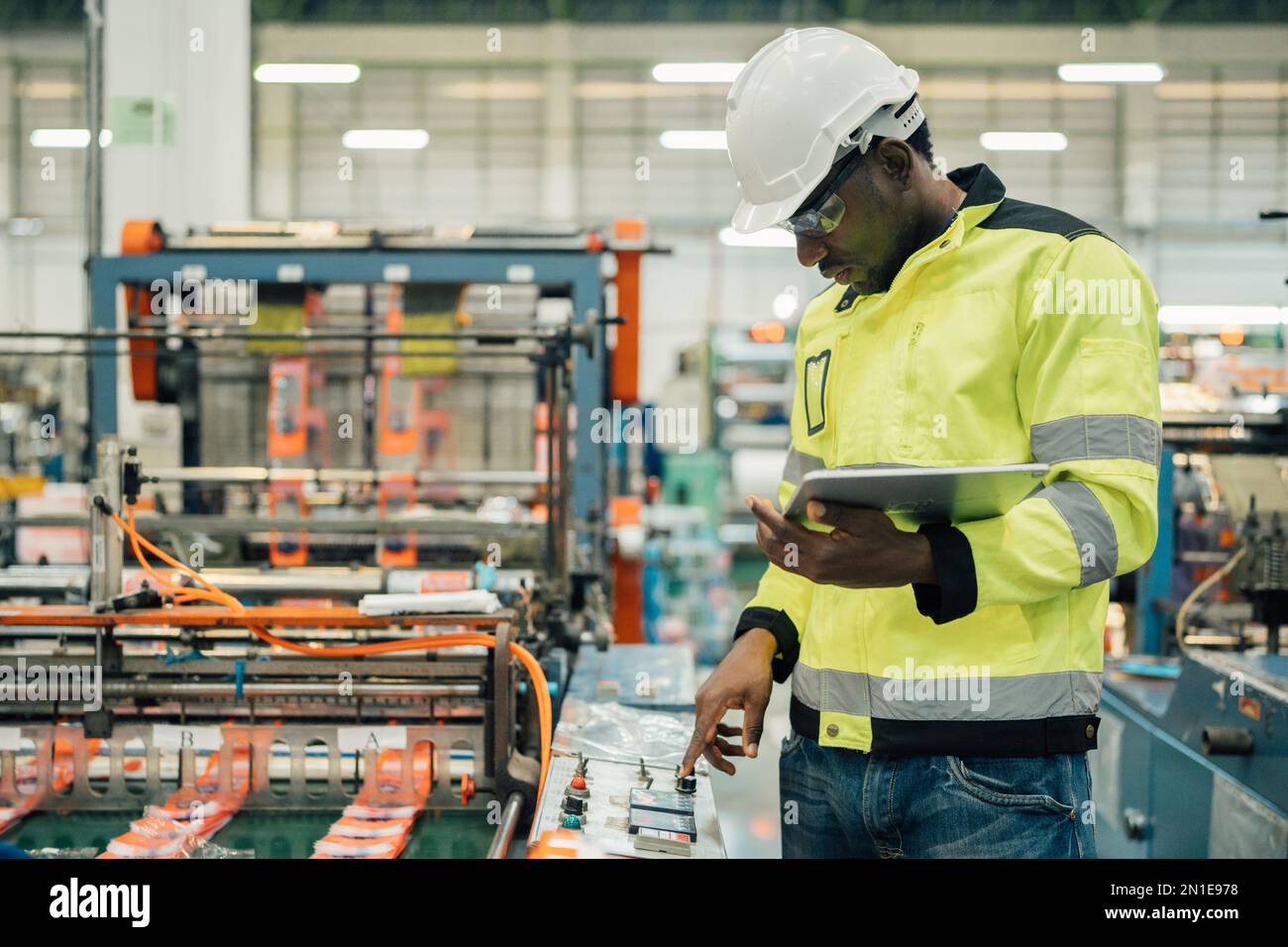 Technician working in factory check functionality while commissioning a ...