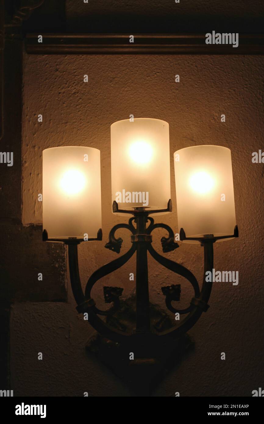 Antique medieval European wall sconce glowing in the darkness Stock ...