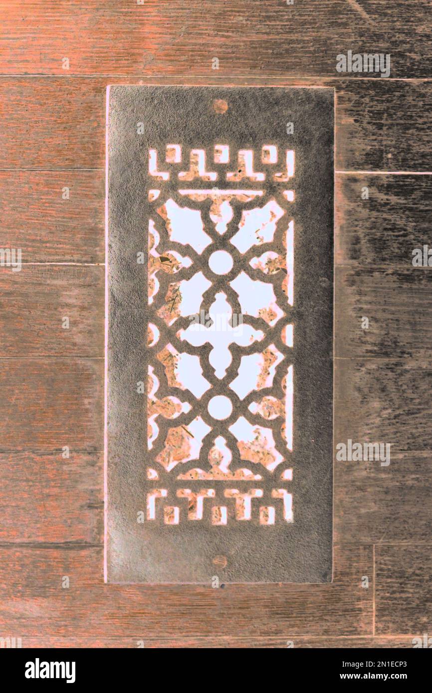 Antique medieval metal floor grate with a decorative repeating pattern ...