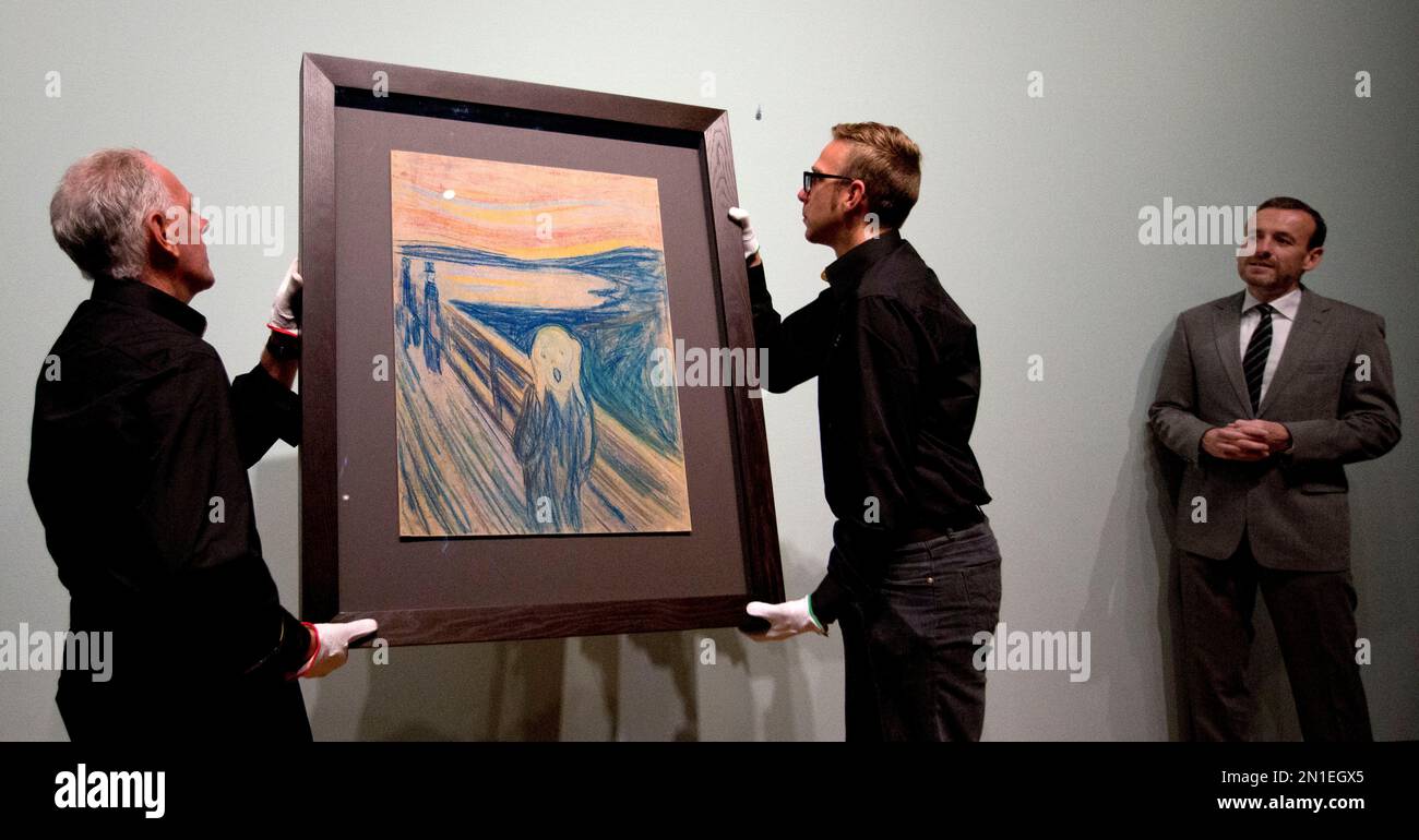 Museum director Axel Ruger, right, watches as staff members hang the ...