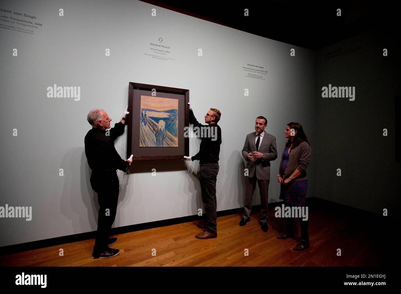Museum director Axel Ruger, second right, watches as staff members hang ...