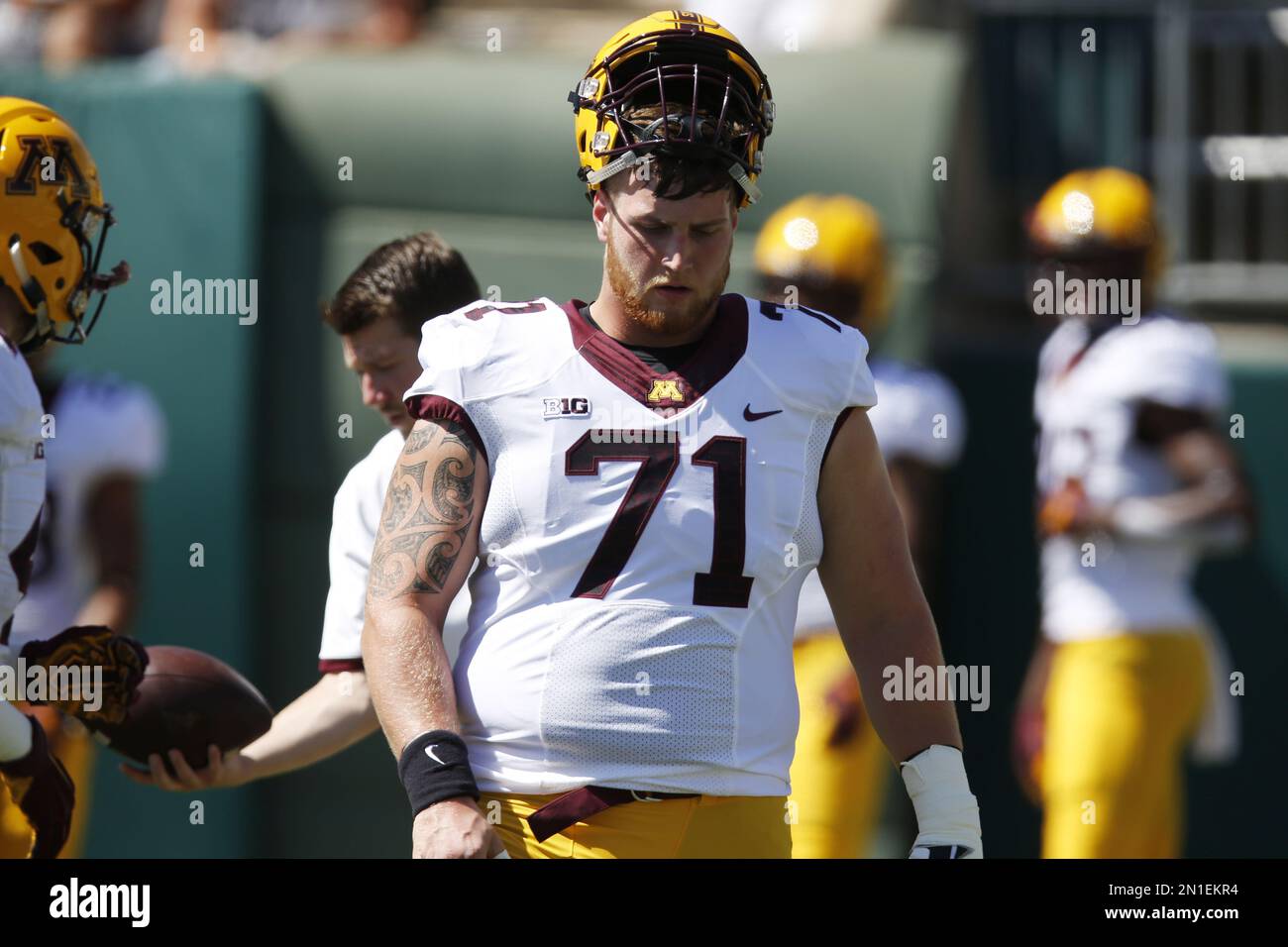Minnesota Golden Gophers offensive lineman Tyler Moore (71) warms up ...