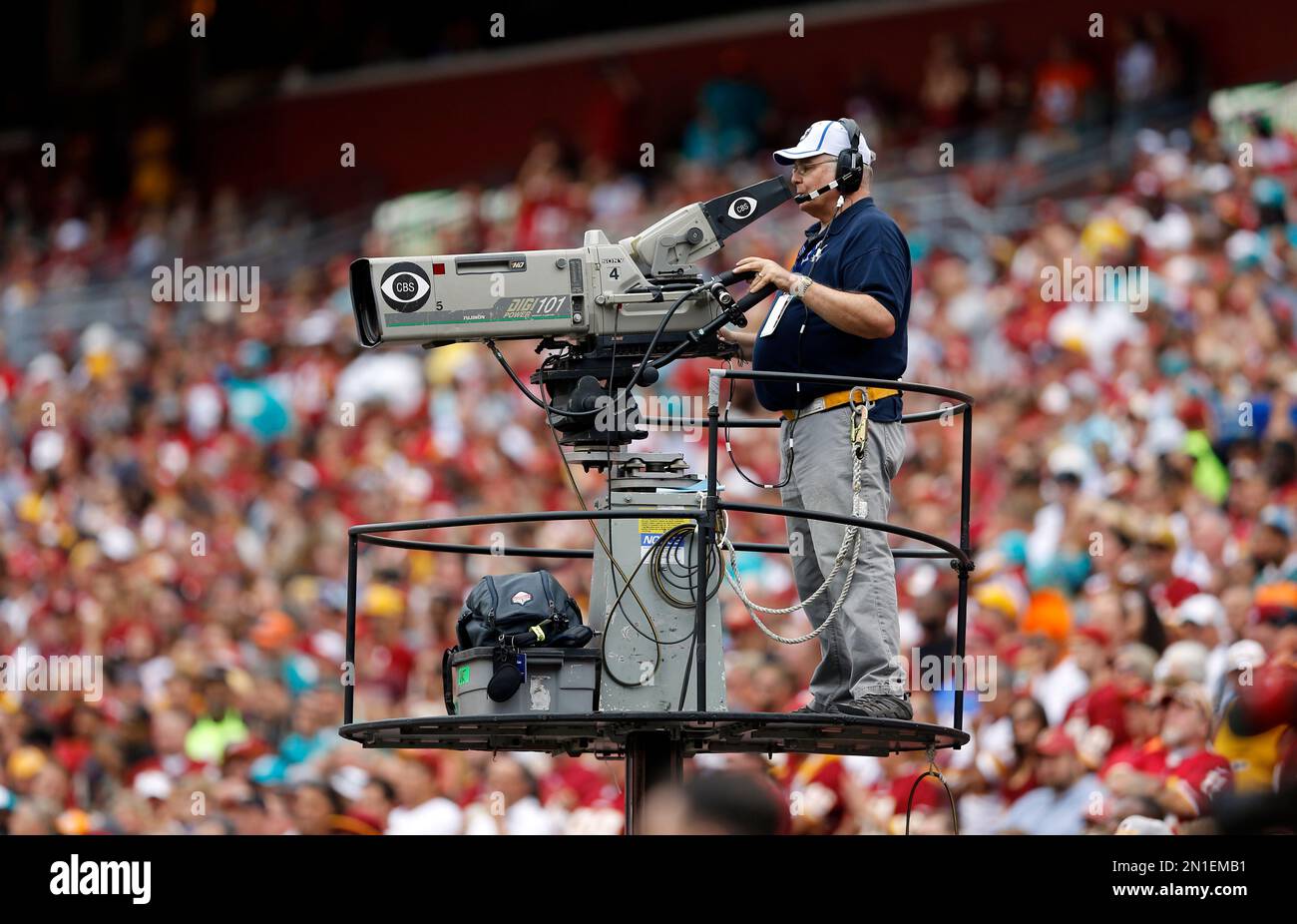 A CBS television cameraman operates a camera during the first half of ...