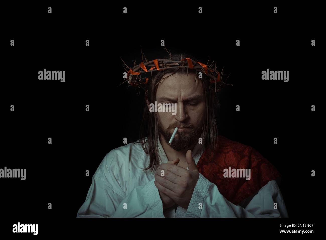 Jesus Christ smokes a cigarette wearing a crown of thorns and white ...