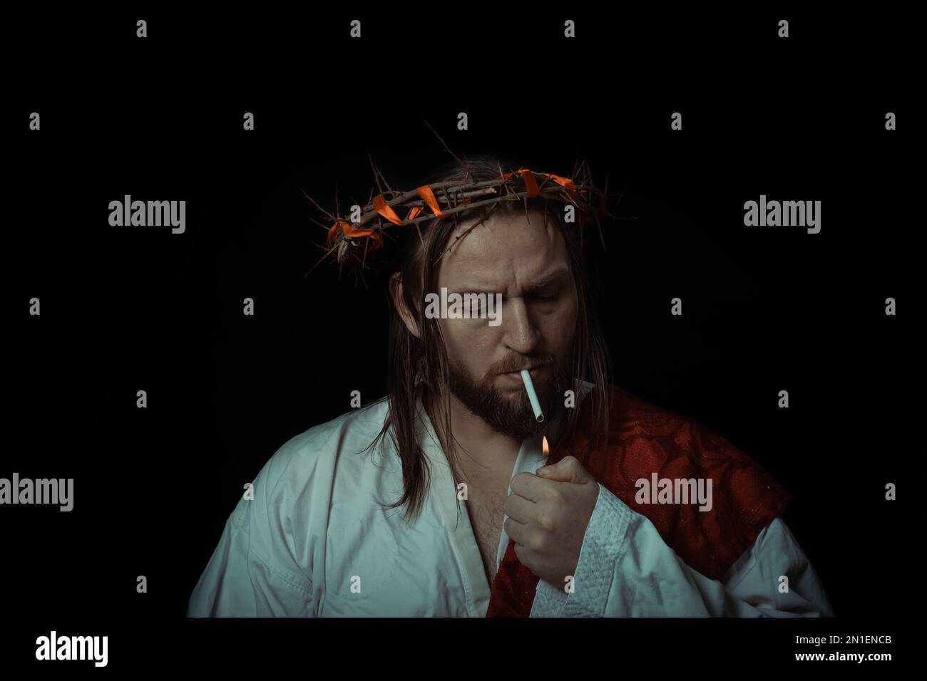 Jesus Christ smokes a cigarette wearing a crown of thorns and white ...