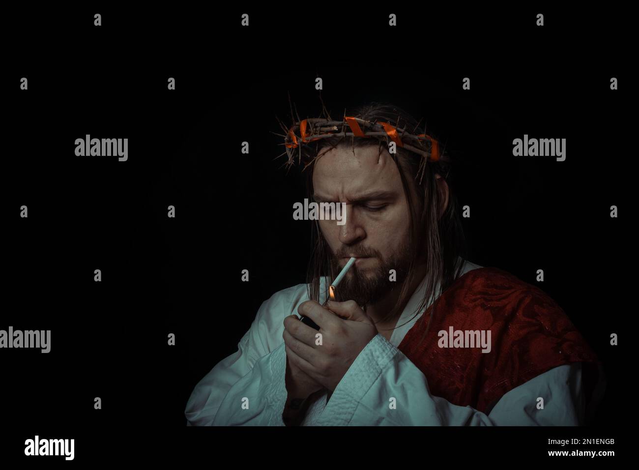 Jesus Christ smokes a cigarette wearing a crown of thorns and white ...