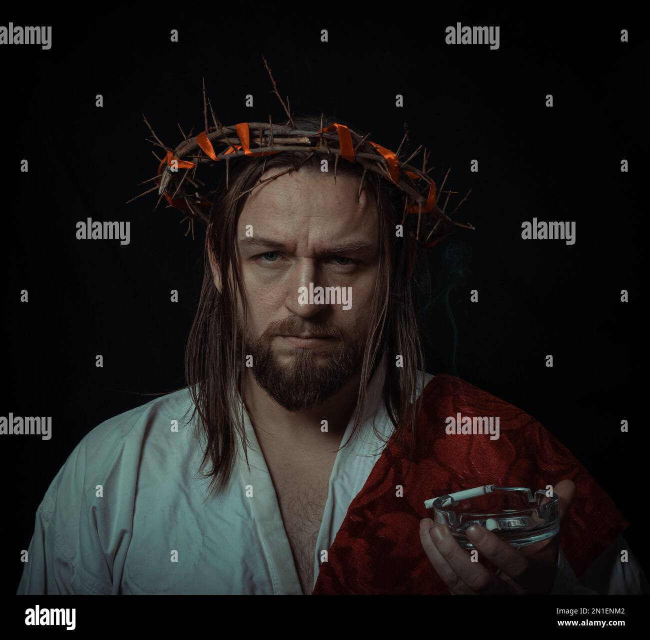 Jesus Christ smokes a cigarette wearing a crown of thorns and white ...