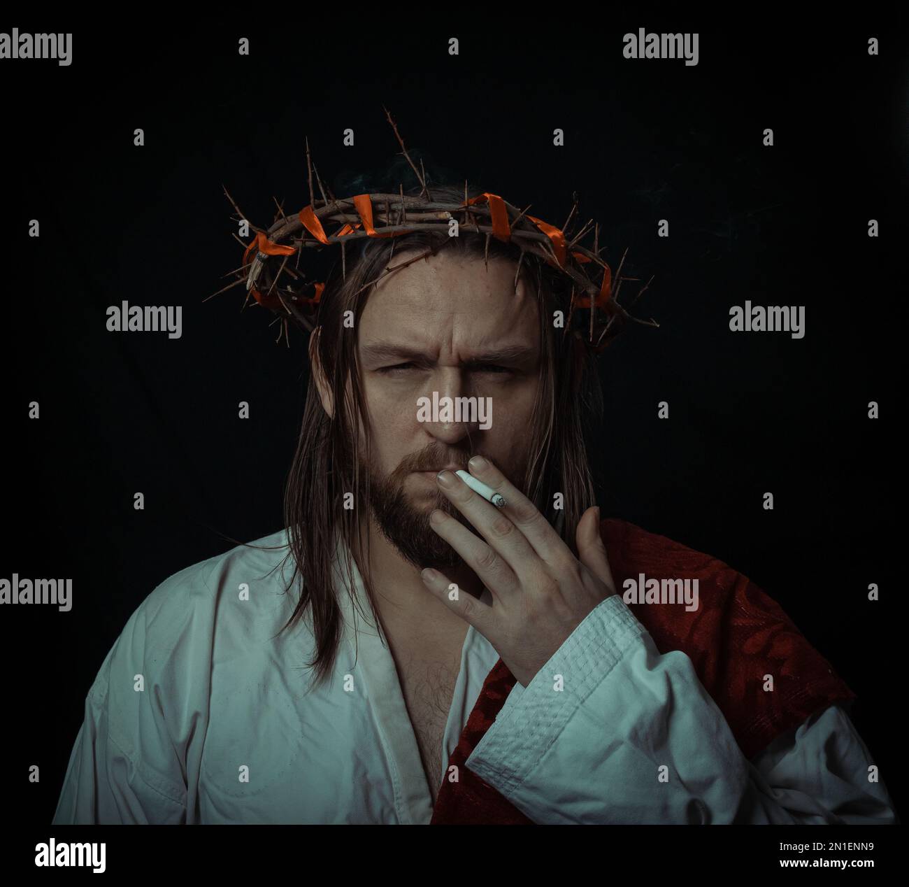 Jesus Christ smokes a cigarette wearing a crown of thorns and white ...