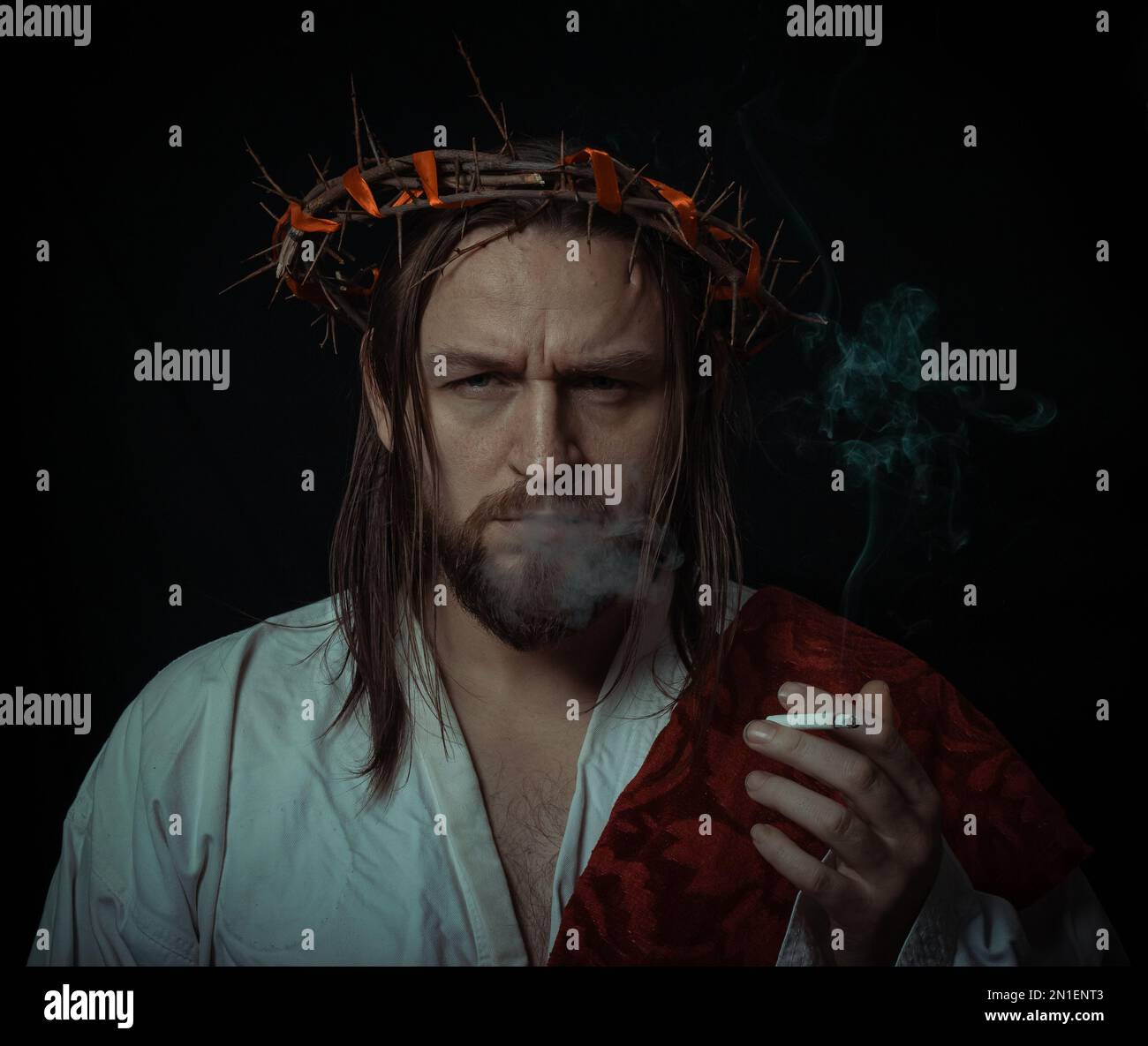 Jesus Christ smokes a cigarette wearing a crown of thorns and white ...