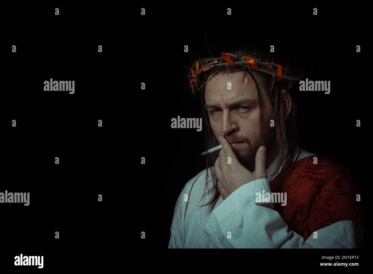 Jesus Christ smokes a cigarette wearing a crown of thorns and white ...