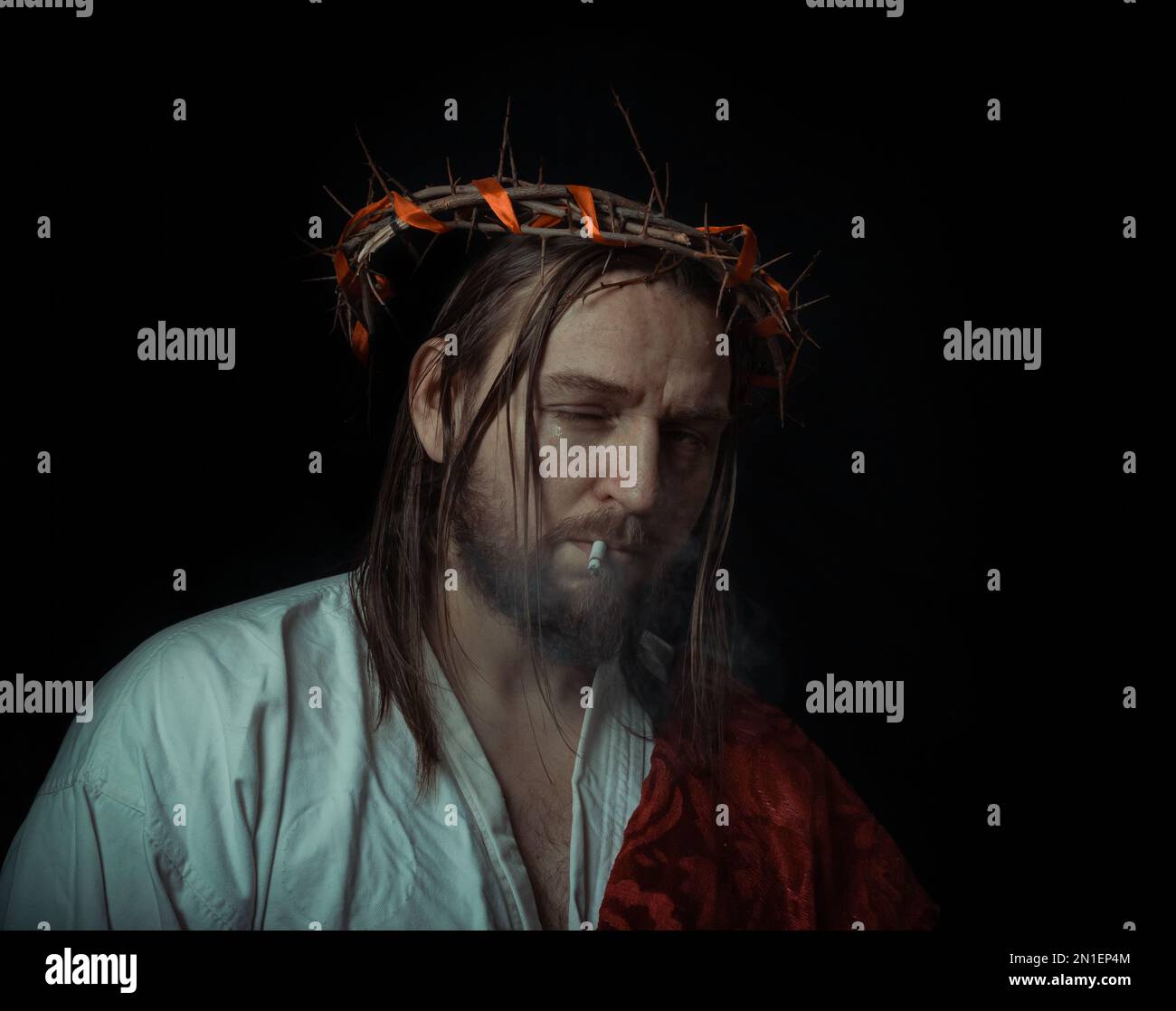 Jesus Christ smokes a cigarette wearing a crown of thorns and white ...
