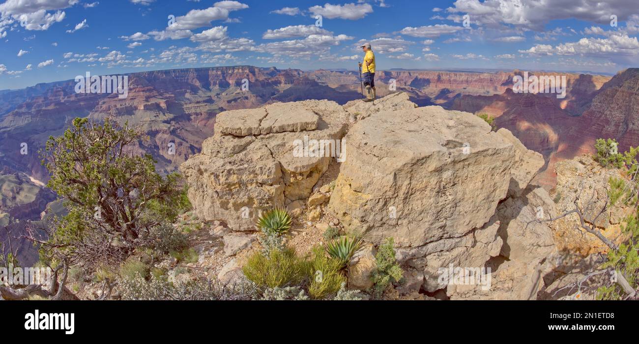 A hiker standing on a rock island at Pinal Point Grand Canyon, Grand ...