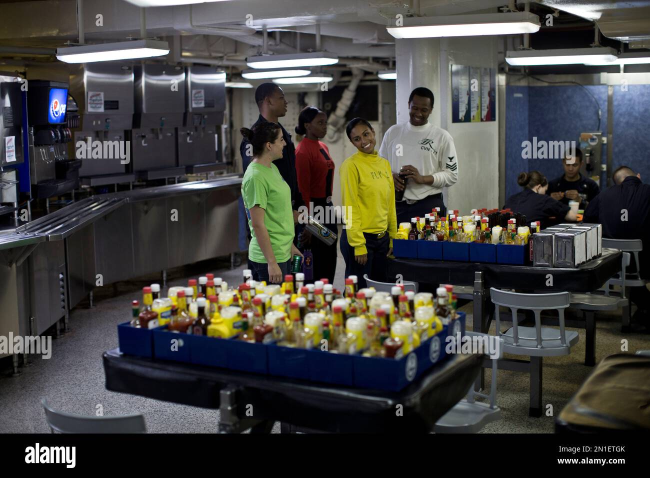 U.S. Navy sailors share a joke inside a mess hall on board the USS ...
