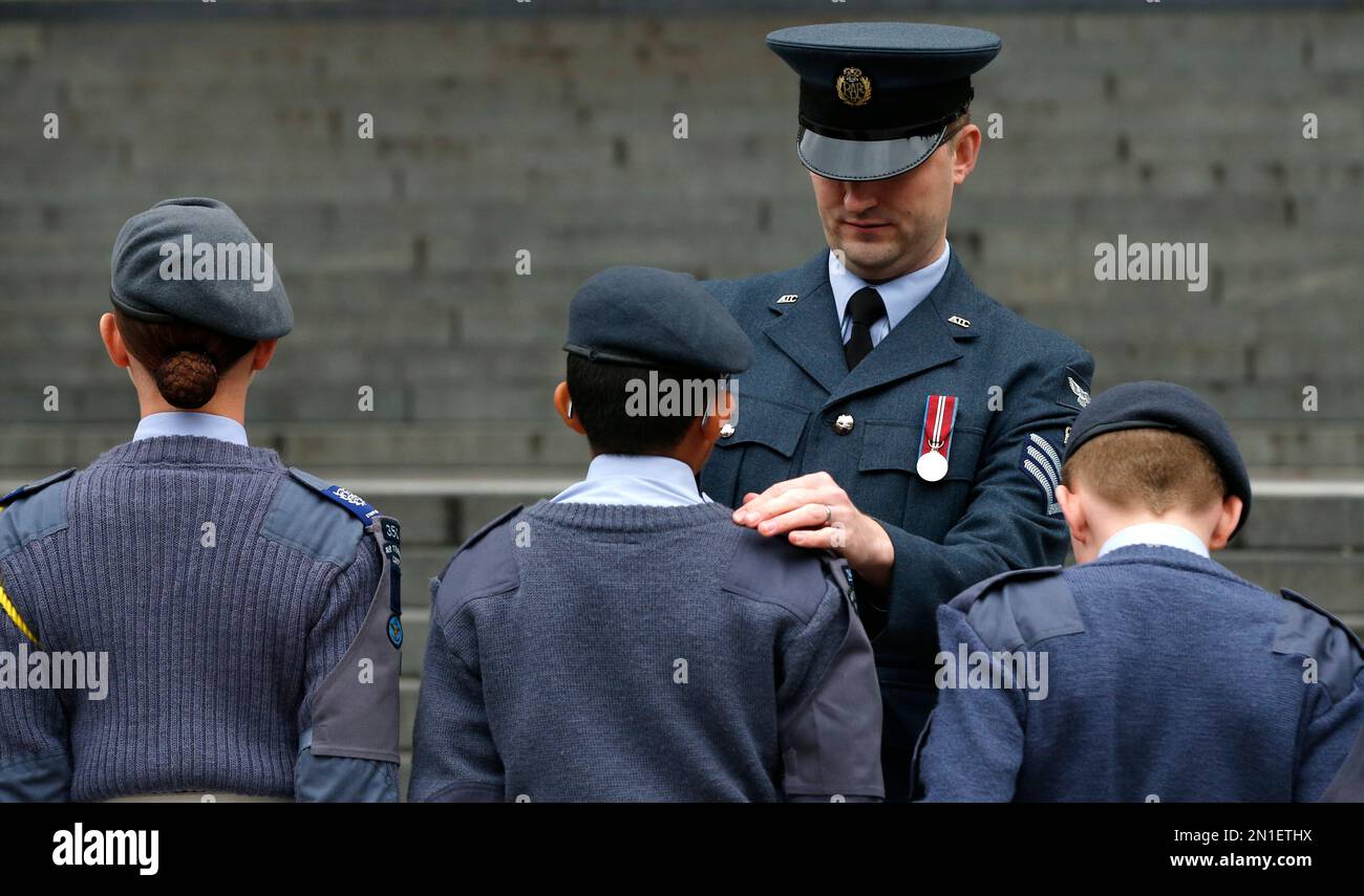 A Royal Air Force non commissioned officer adjusts the uniform of an ...